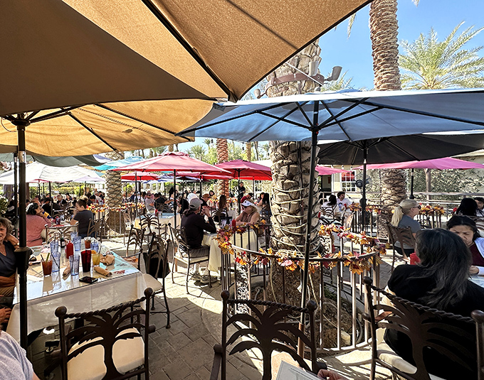 The bustling patio scene under colorful umbrellas proves that outdoor dining in the desert isn't just possible&mdash;it's practically mandatory.