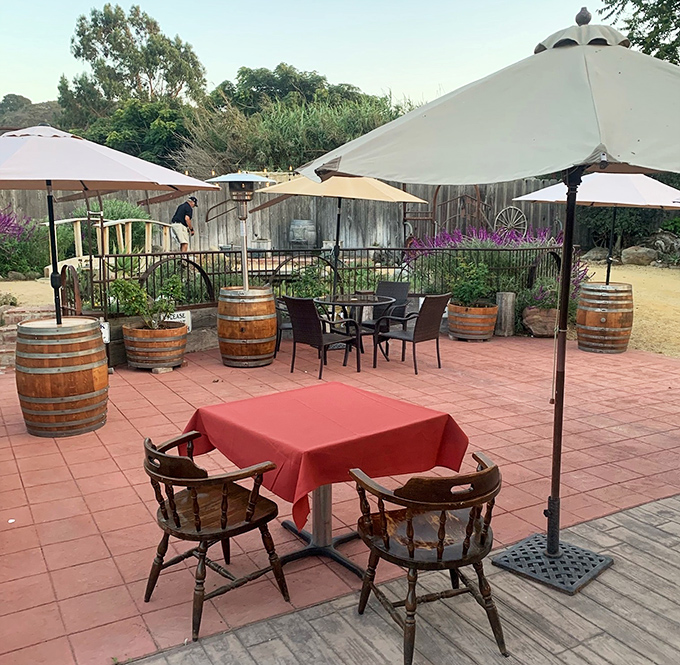 Al fresco dining California-style: wine barrels, umbrellas, and the scent of oak smoke in the air. Even the outdoor tables get the signature red tablecloth treatment.