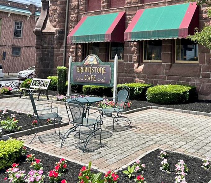 Outdoor patio seating surrounded by blooming flowers transforms any meal into a garden party celebration experience.