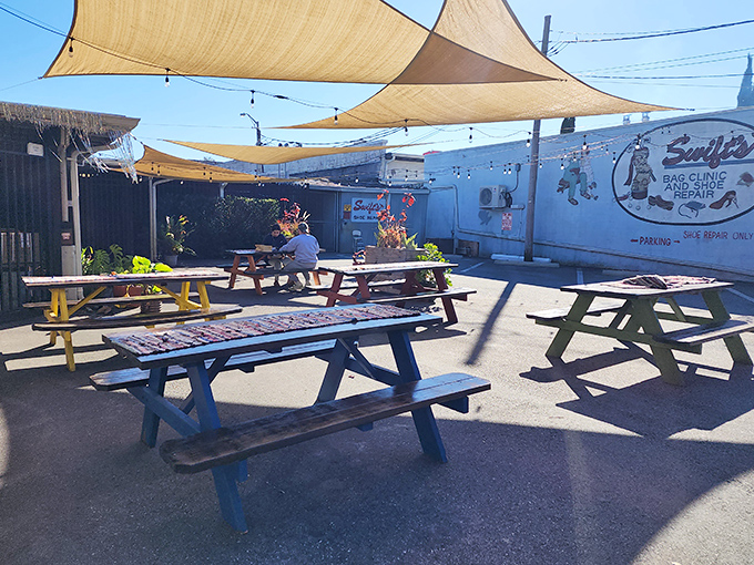 Outdoor picnic tables under sail shades &ndash; where you can pretend the calories don't count because you're technically dining al fresco.