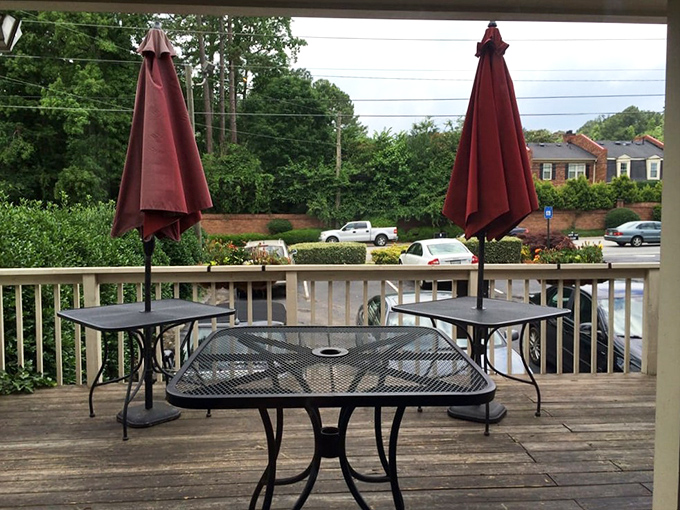 The outdoor patio offers a front-row seat to Atlanta's morning rhythms, with burgundy umbrellas standing guard against too much Southern sunshine.