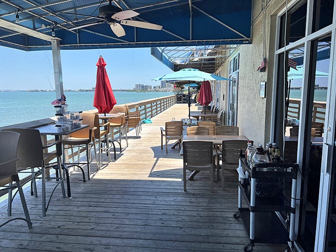 Waterfront dining where the view competes with the food for your attention. Those umbrellas aren't just for shade&mdash;they're keeping your breakfast secrets safe.