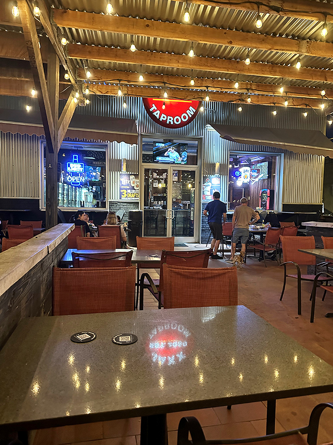 The outdoor seating area transforms into an urban oasis at night, string lights creating a magical atmosphere for sandwich devotion.