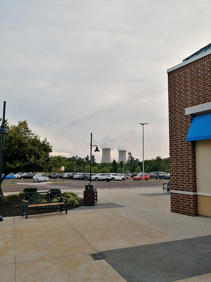 In the distance, cooling towers create an unusual backdrop for fashion finds. Only in Pennsylvania can nuclear energy and Nike outlets coexist.