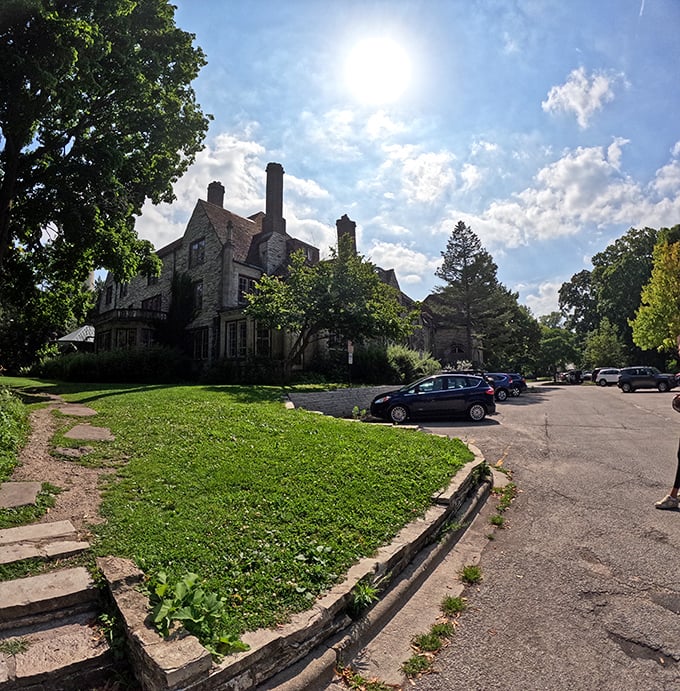 Beyond the lighthouse stands a stately stone building, part of the historic complex that makes this site more than just a single tower.