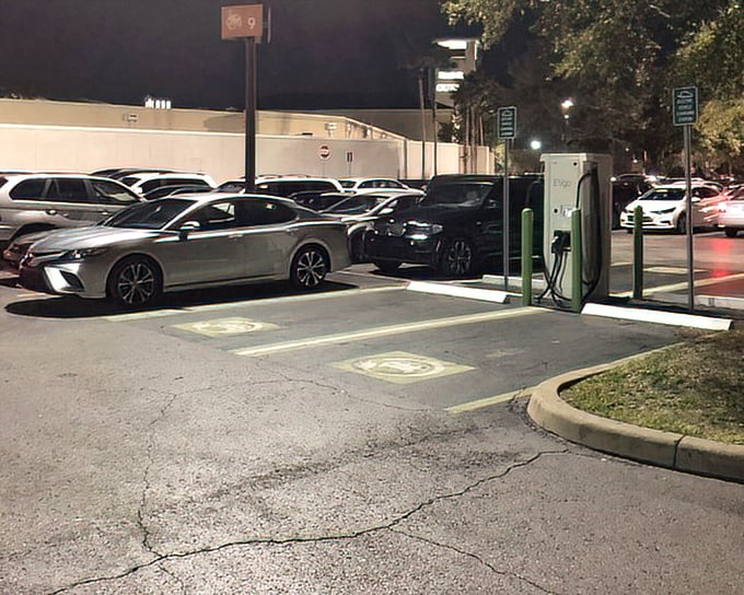 Even the parking lot tells a story—evening shoppers hunting for spaces like bargain hunters searching for that last discounted designer handbag.