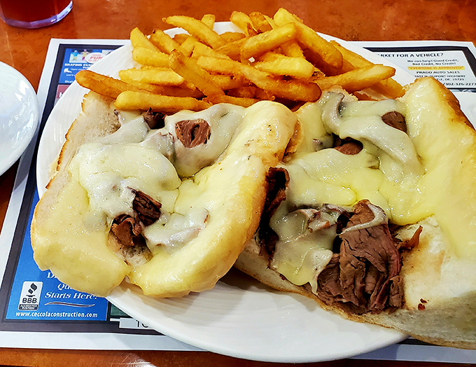 Behold the cheesesteak in all its glory &ndash; tender beef and melted cheese embracing each other on a perfect roll. This isn't just lunch; it's an experience.