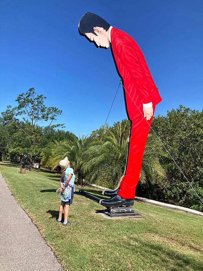 When art towers over reality, even adults become wide-eyed children again, measuring themselves against imagination's scale.