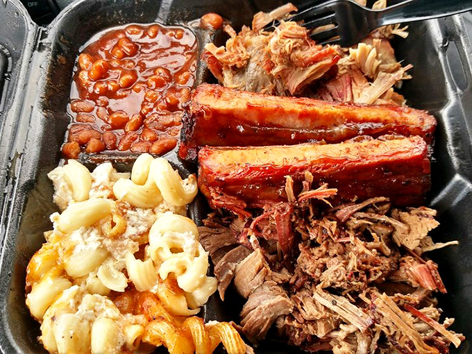 A barbecue platter that's basically a family reunion of meats and sides, all getting along beautifully on one harmonious tray.