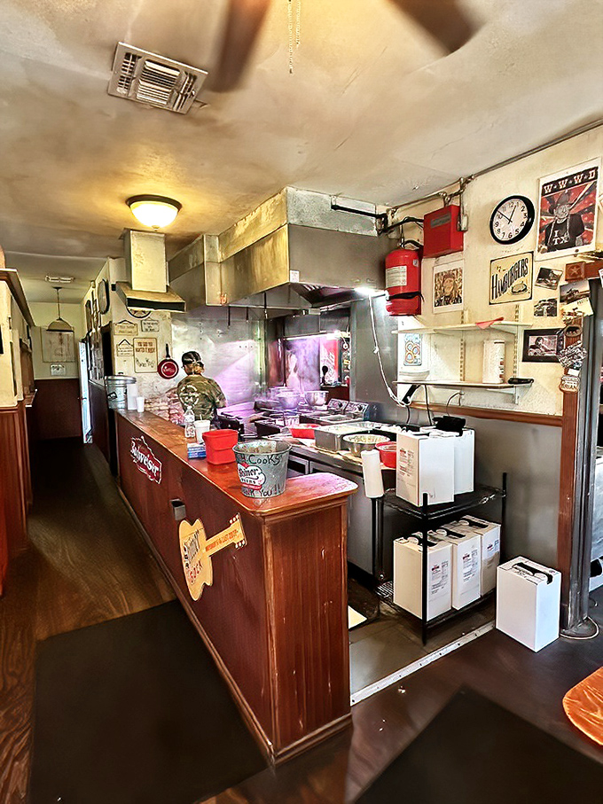 The open kitchen layout means you can watch burger magic happen in real time. That grill has probably seen more action than a Texas football field.