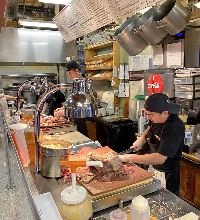 The heart of any great deli: where skilled hands transform simple ingredients into edible poetry.