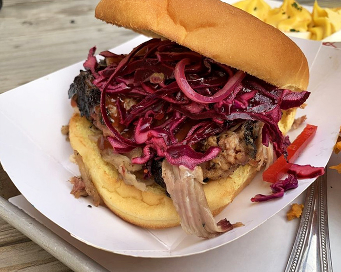 This isn't just a sandwich – it's architecture of flavor with layers of smoky meat and tangy slaw creating the perfect balance in every bite.
