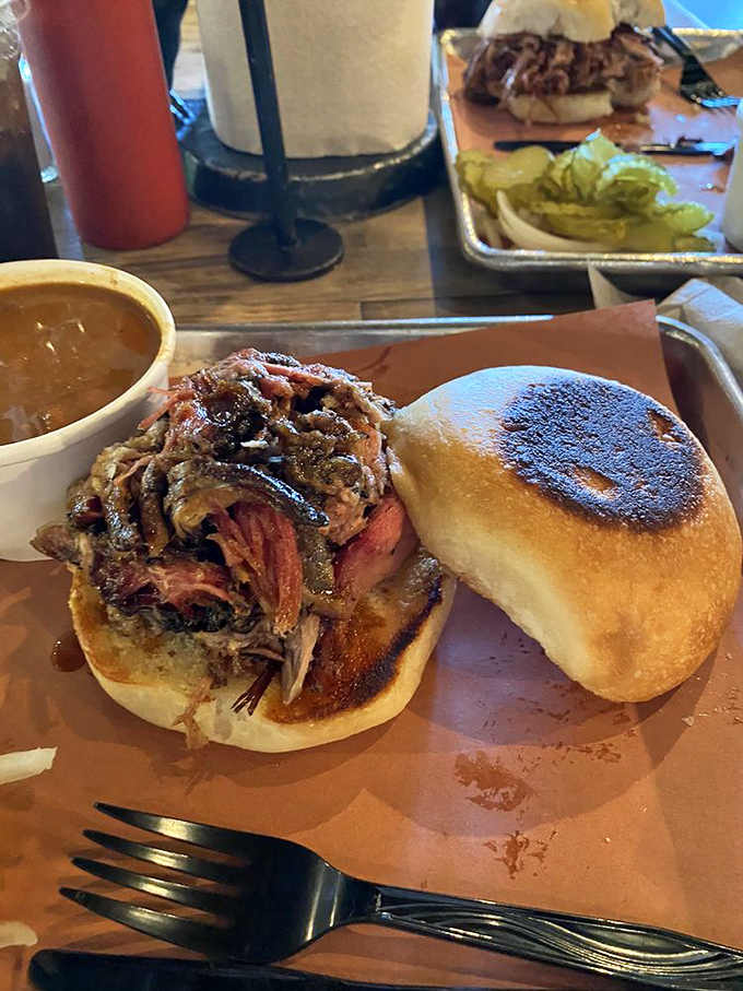 The pulled pork sandwich&mdash;where bread becomes merely a delivery system for smoky, juicy perfection. Napkins required, restraint impossible.