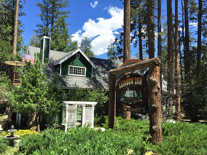 The Rainbow Inn embodies mountain charm with its forest-green trim and rustic wooden sign &ndash; the kind of place where check-in comes with stories and local recommendations.