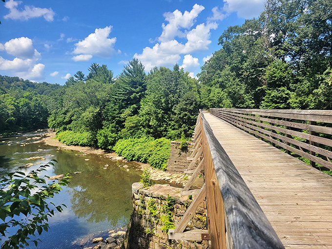 The wooden bridge along Redbank Valley Trail offers both passage and pause&mdash;a perfect spot to appreciate Pennsylvania's pristine waterways.