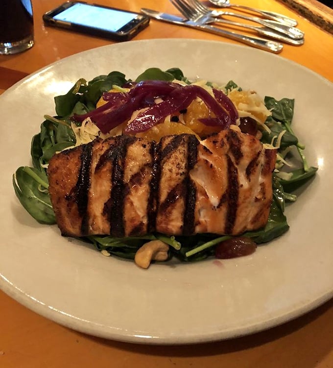 Grilled salmon perched atop fresh greens like it's posing for a magazine cover&mdash;healthy eating never looked so tempting.