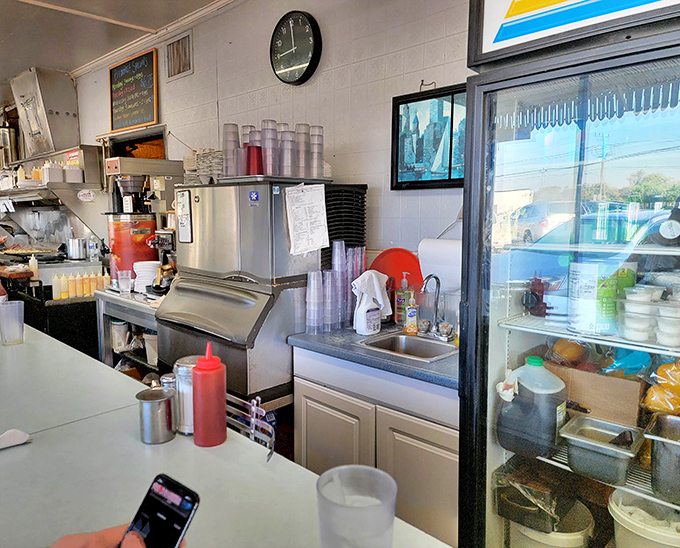 Behind the counter, where breakfast magic happens with military precision and a splash of short-order poetry.
