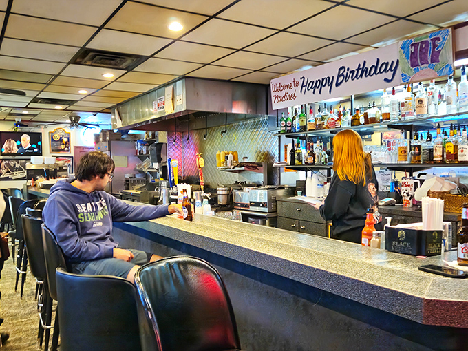 The "Happy Birthday" banner stays up year-round because at Nadine's, every day someone's celebrating something, even if it's just surviving Tuesday.