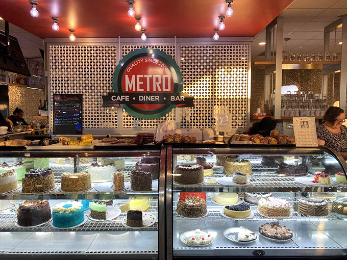 Where dreams are displayed under glass—each cake a masterpiece that whispers, "Diet tomorrow, indulge today."