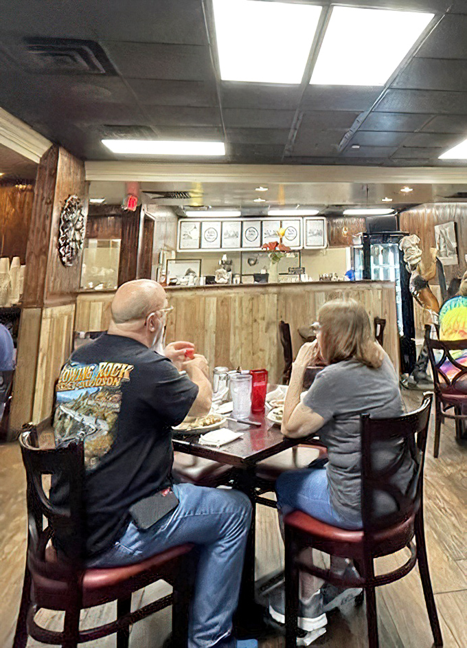 The service counter reveals the organized chaos of a well-run kitchen – where culinary magic happens behind wooden fortress walls.