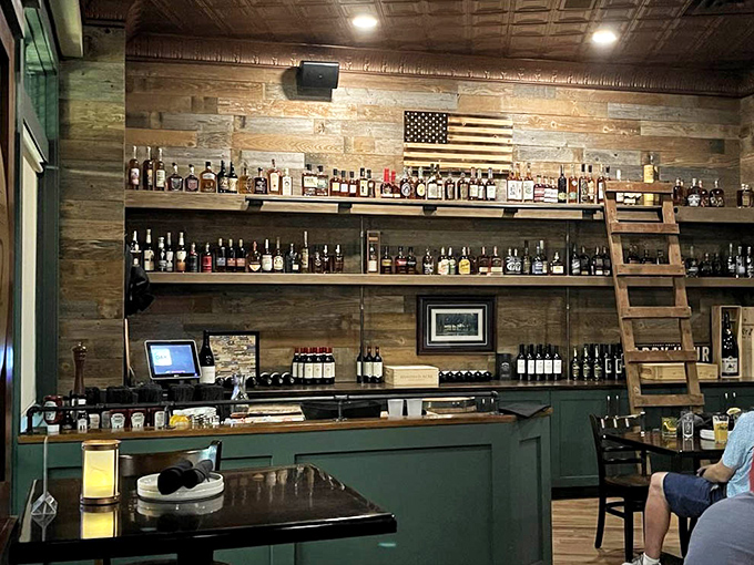 The rustic-meets-refined bar wall could double as a whiskey museum, with bottles arranged like precious artifacts waiting to be discovered by appreciative patrons.