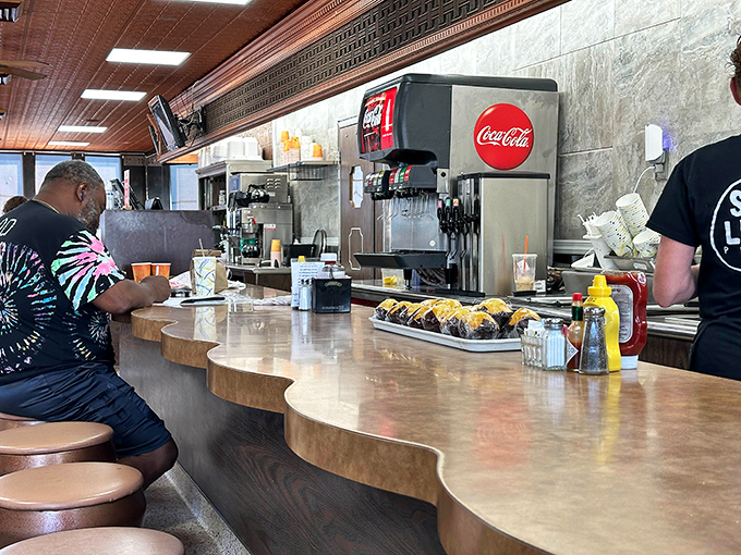 The counter where regulars gather and strangers become friends over perfect cup after cup.