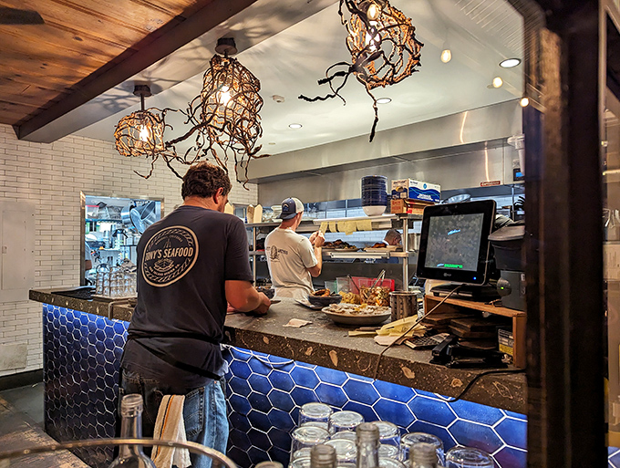 The open kitchen reveals the choreographed dance of creating seafood perfection. Those blue tiles add a Mediterranean touch to California's coast.