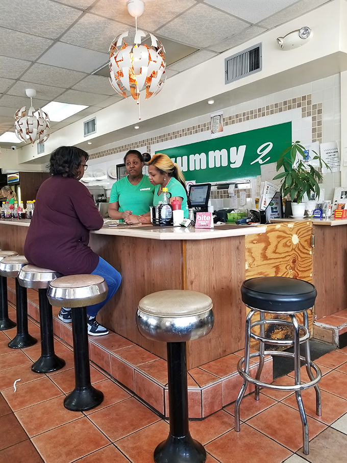 The heart of Yummy 2 &ndash; where staff in matching green shirts orchestrate breakfast magic with practiced efficiency.