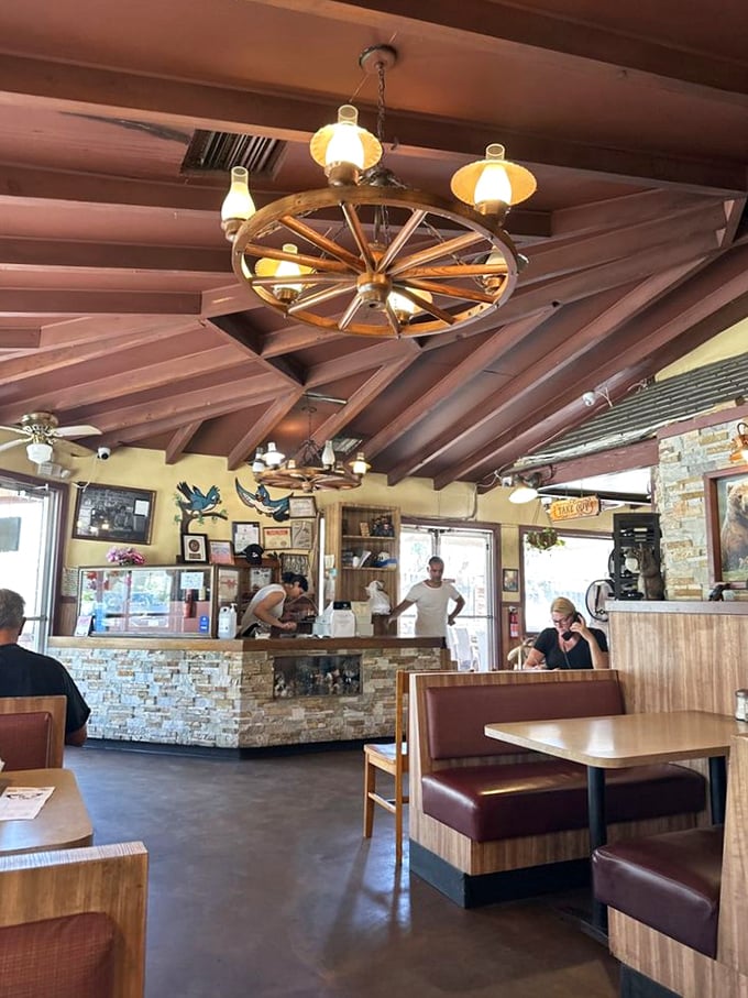 Where the magic happens. The wagon wheel chandeliers cast a warm glow over the dining room, making everyone look like they're in a BBQ commercial.