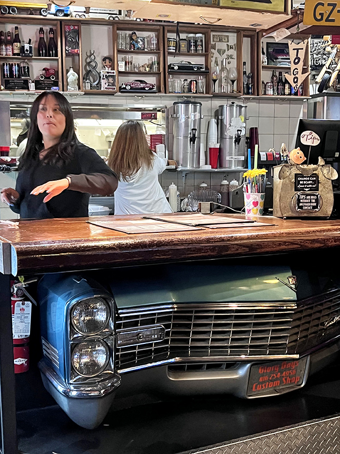 The front counter doubles as a classic car showcase. When your order station is built from a Cadillac, you know you're not at a chain restaurant.