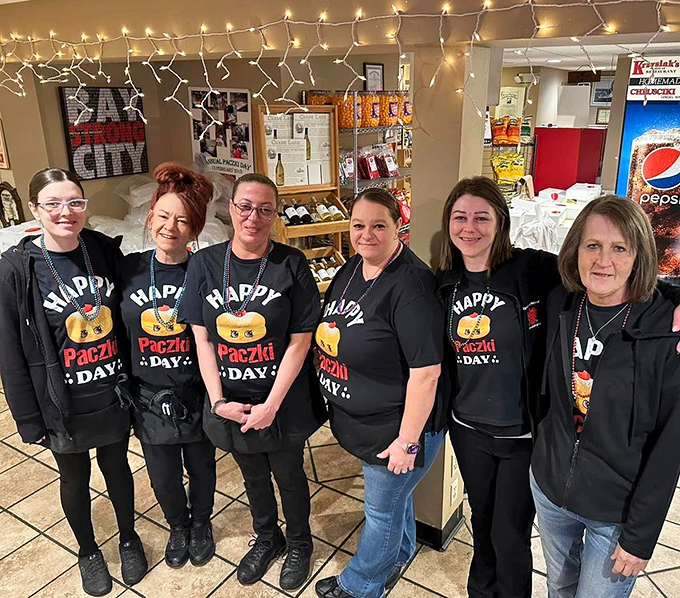 The team behind the magic, wearing their "Happy Paczki Day" shirts with pride—because great food always comes with a side of genuine smiles.