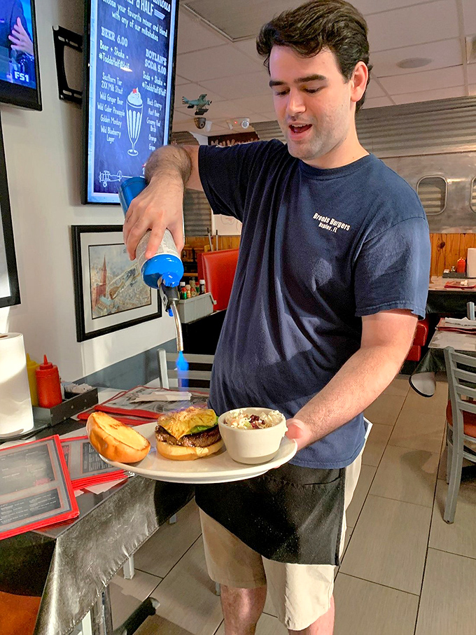 Service with both a smile and a blue milkshake&mdash;the kind of multitasking we can all appreciate.