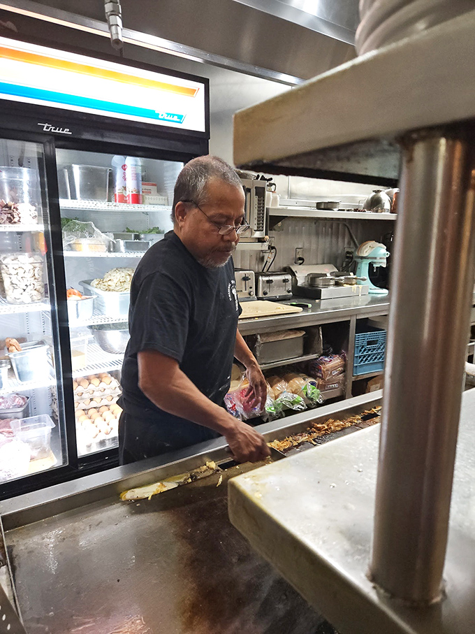 The wizard behind the curtain, transforming simple ingredients into the comfort food that Portland craves at 3 AM.