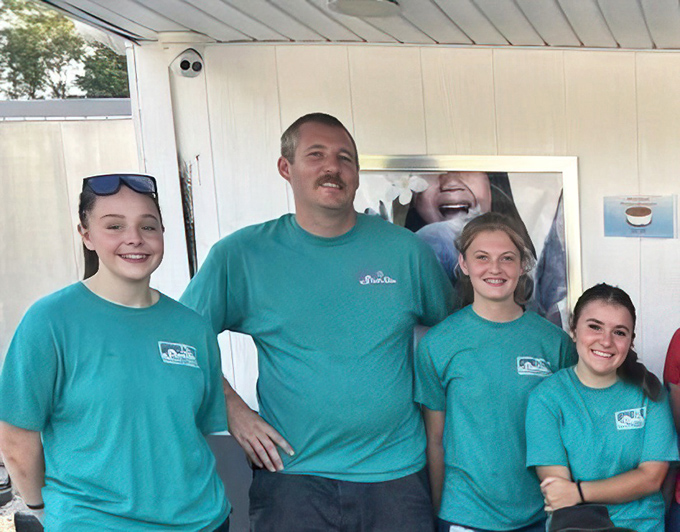 The teal-shirted crew that keeps the magic happening. Drive-in staff are the unsung heroes of summer entertainment.
