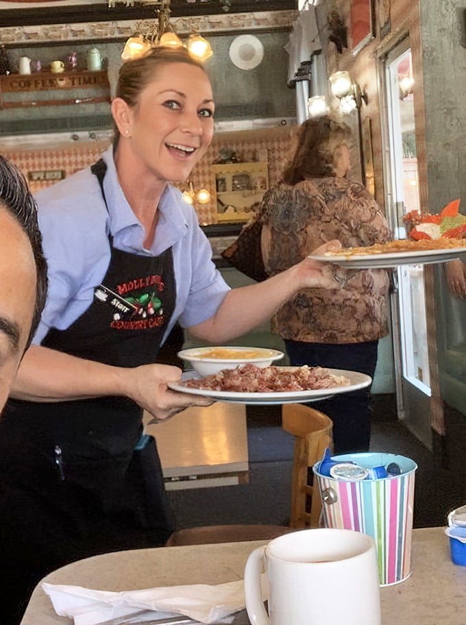 The servers don't just bring food &ndash; they deliver happiness with a side of efficiency. That smile says, "Yes, we can bring more syrup."