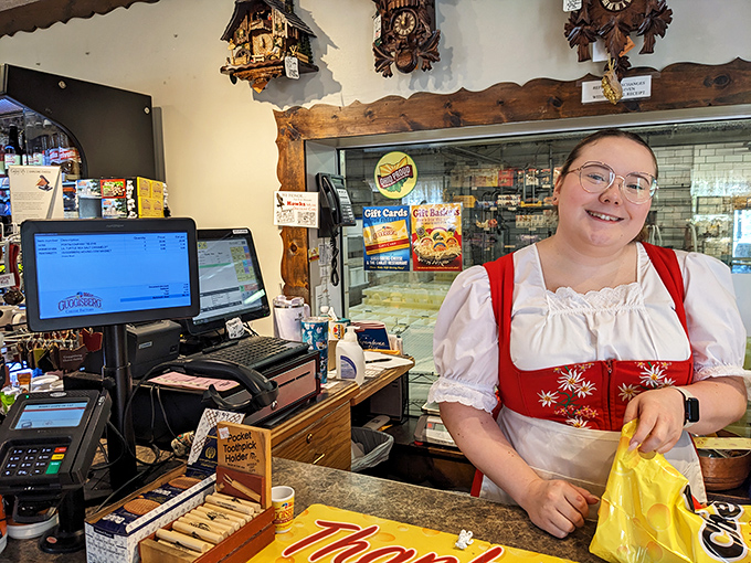 Traditional Swiss attire meets modern hospitality at the checkout counter. That smile says, "Yes, you should definitely buy more cheese."