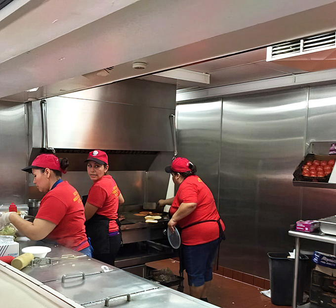 Behind every great burger is a dedicated kitchen crew, working their magic on the flat-top grill where beef patties transform into objects of desire.