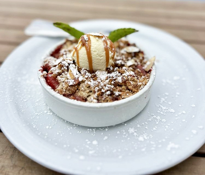 A berry crumble that whispers, "Save room for me" throughout your entire meal. That scoop of vanilla seals the deal.