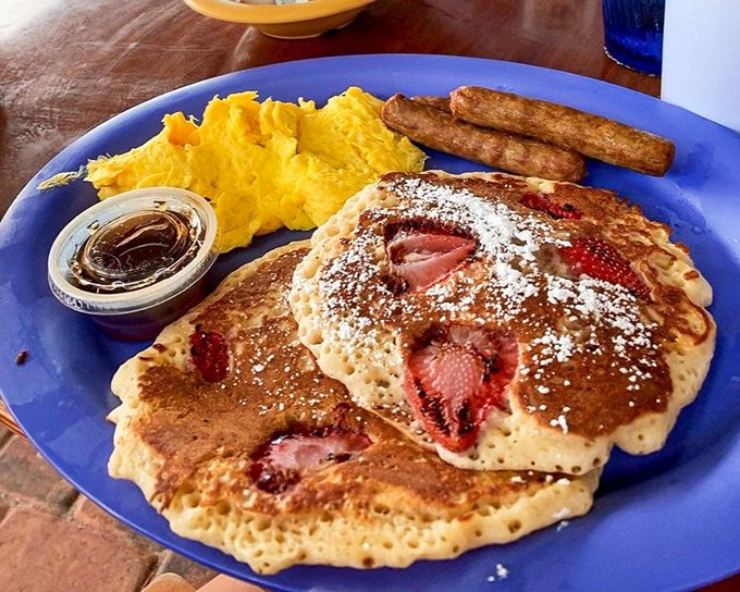 Pancakes that have been kissed by strawberries, dusted with powdered sugar, and served alongside eggs that match the sunny Florida disposition.