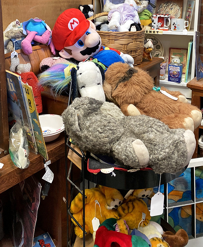 Stuffed animal mountain featuring Mario himself, clearly taking a break from rescuing princesses to hang out with teddy bears who've seen better days.