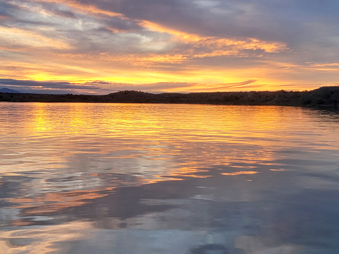 Sunset turns Alamo Lake into liquid gold, proving that Mother Nature remains the world's most talented painter, no commission required.