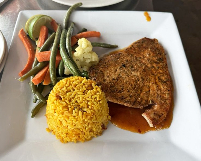 A perfectly seared fish fillet lounges on a bed of yellow rice like a sunbather on Key West's finest beach&mdash;simple, elegant, and utterly satisfying.