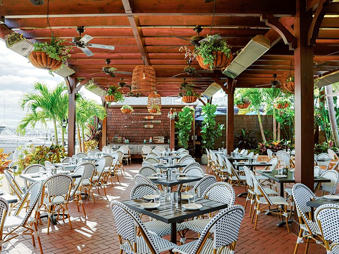 Dining al fresco Florida-style, where ceiling fans stir the air like gentle ocean breezes and hanging plants create a garden oasis.
