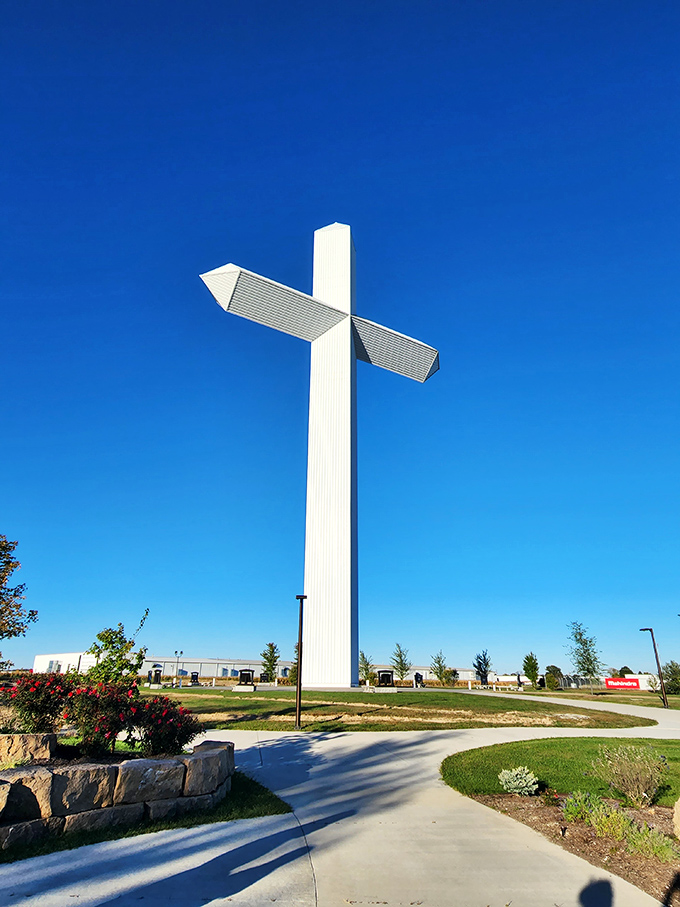 The Cross at the Crossroads reaches skyward against an impossibly blue Illinois sky, a landmark visible for miles that says "you've arrived" better than any GPS.