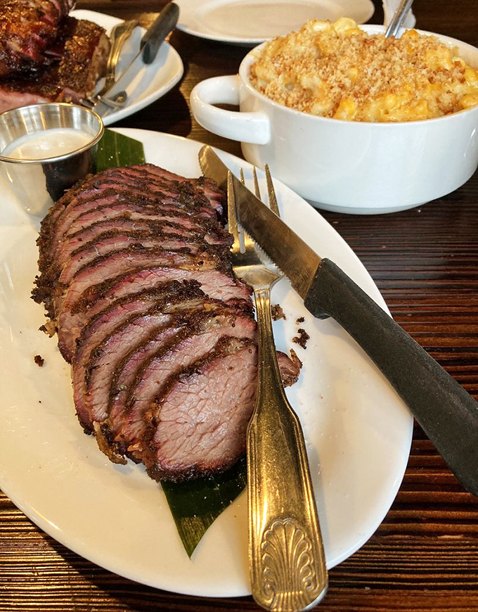 The tri-tip, sliced thin enough to read through, showcases a perfect smoke ring that took hours to achieve but seconds to appreciate.