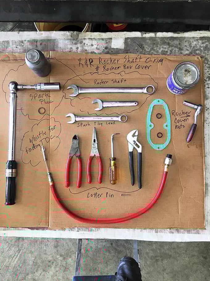 A bright yellow experimental aircraft undergoes restoration, its vibrant color scheme a stark contrast to the utilitarian surroundings of the workshop.