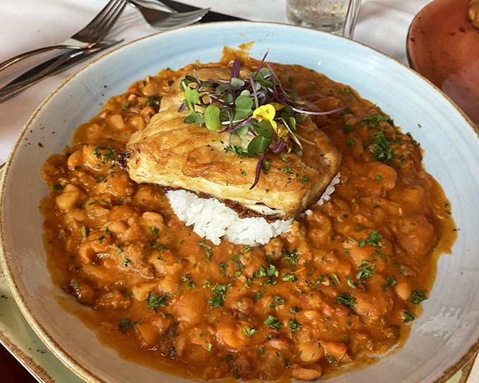 Fish perched atop a sea of beans and rice&mdash;a dish that makes you wonder why you'd ever order anything else.