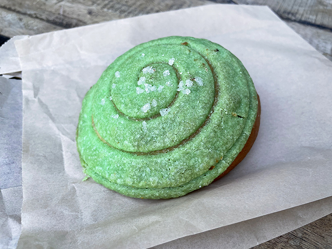 The ube custard bun&mdash;a vibrant green treat that brings unexpected sweetness and a pop of color to your coffee ritual.