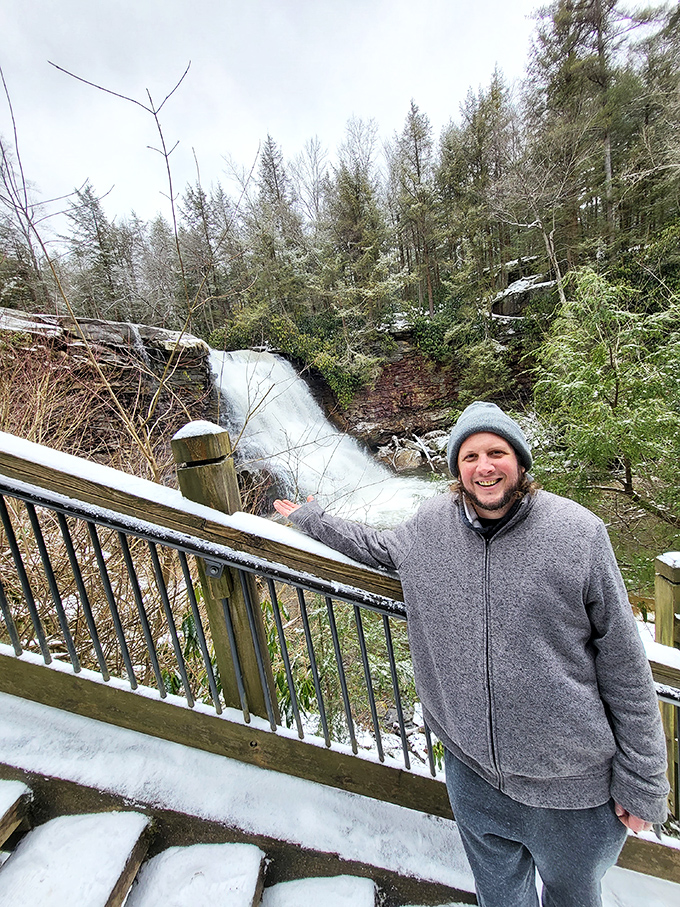 Even in winter, the falls draw visitors who brave the cold for nature's frozen spectacle. That smile says it was absolutely worth it.
