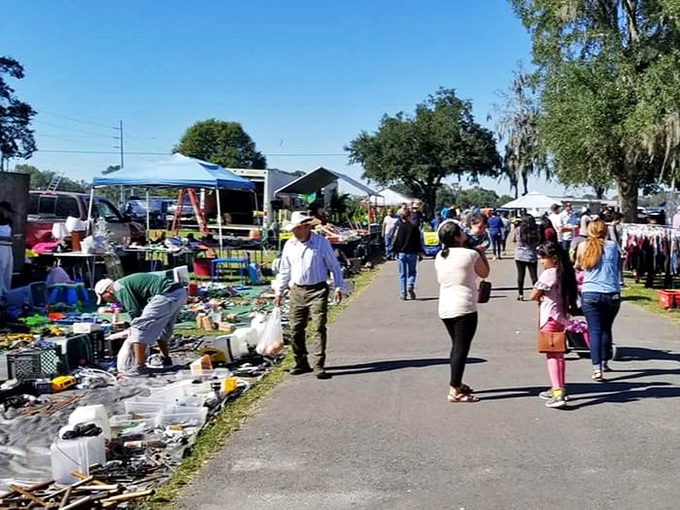 Weekend treasure hunters on the prowl. That gentleman in the hat has the focused expression of someone who knows exactly what vinyl record he's searching for.